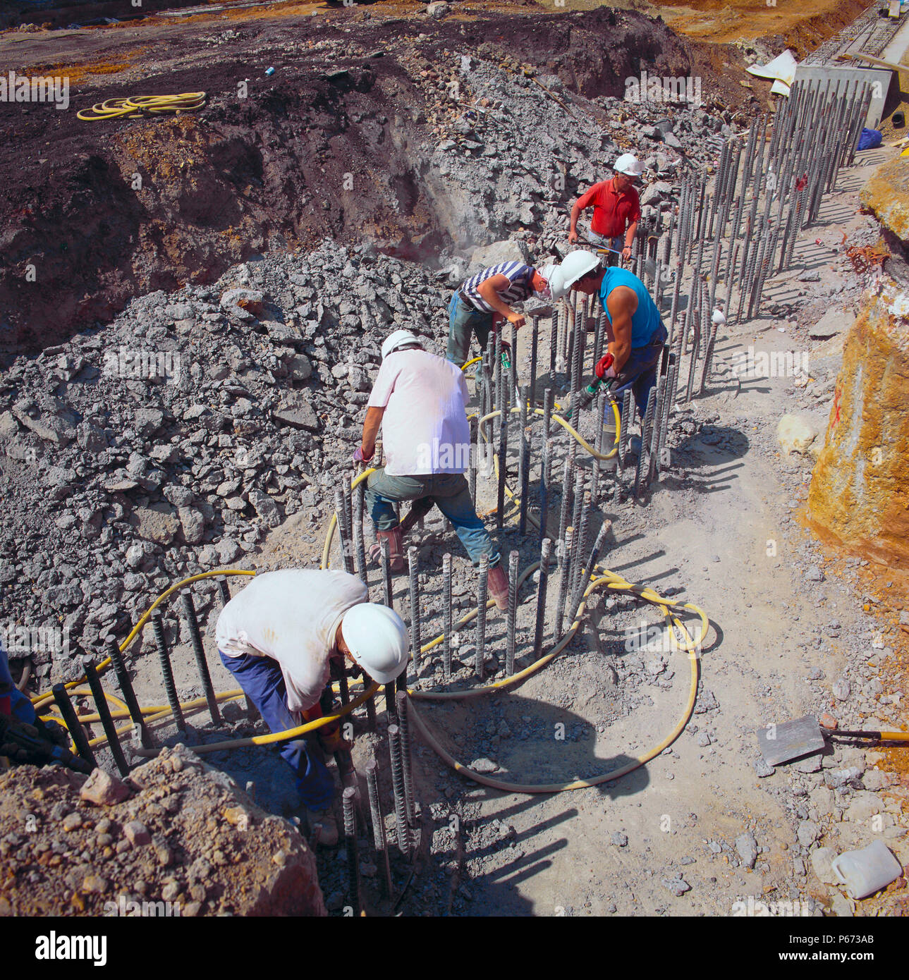 Workers break out pile caps by hydraulic hammers Stock Photo - Alamy