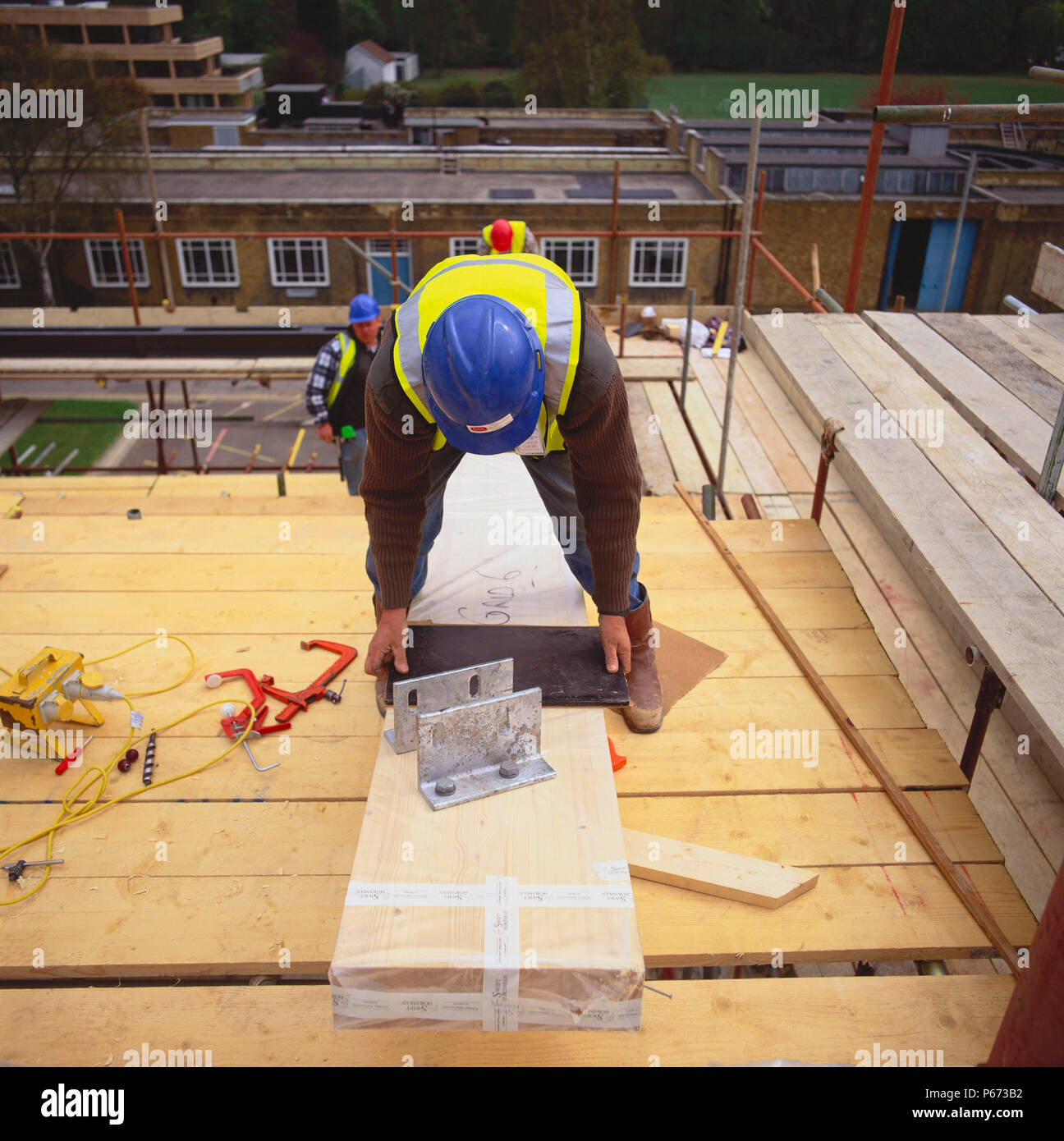 Worker prepares timber for decking on residential block Stock Photo - Alamy