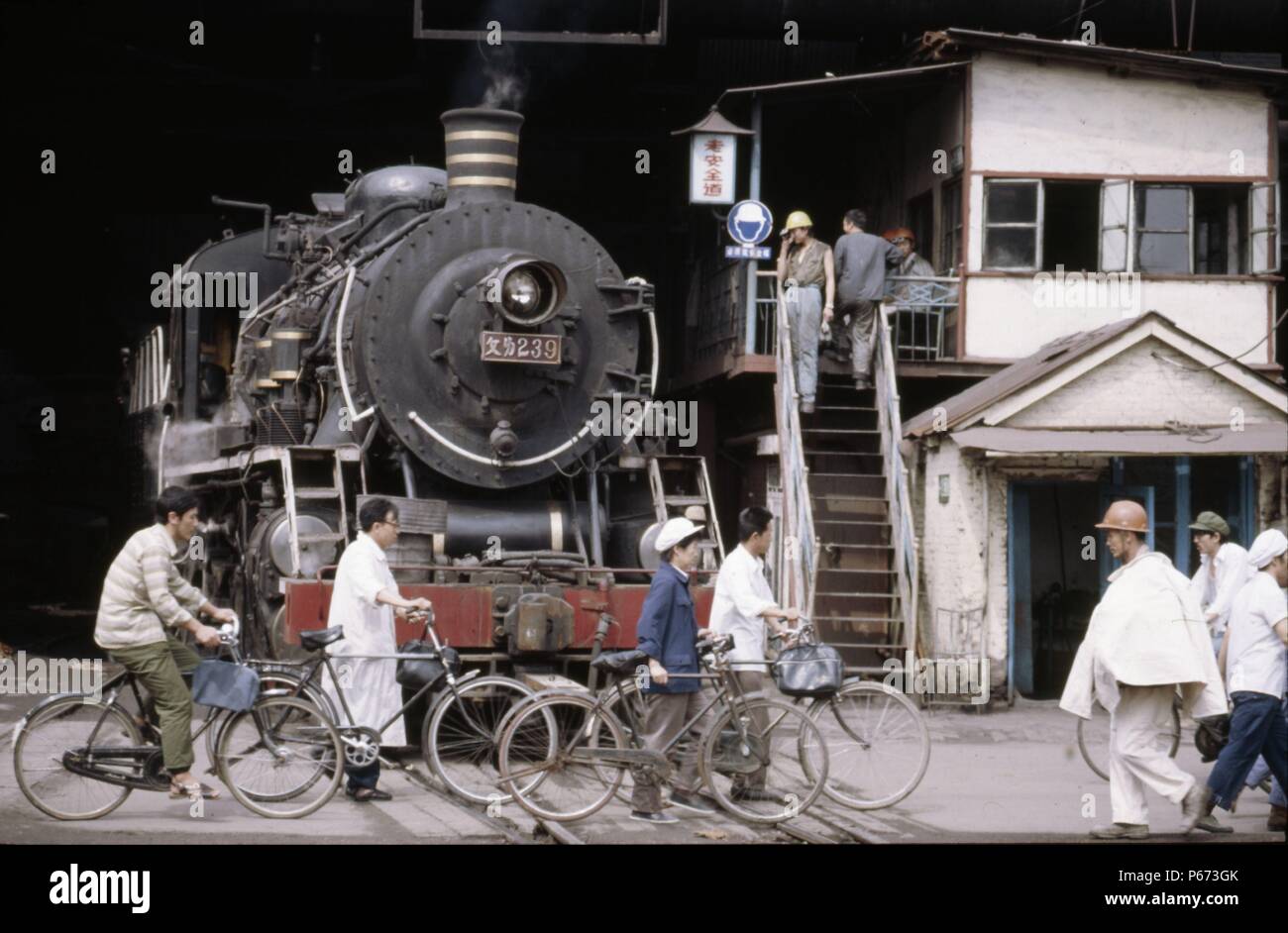 A YJ Clan Prairie 2-6-2 passes at a road crossing in Anshan Iron ...