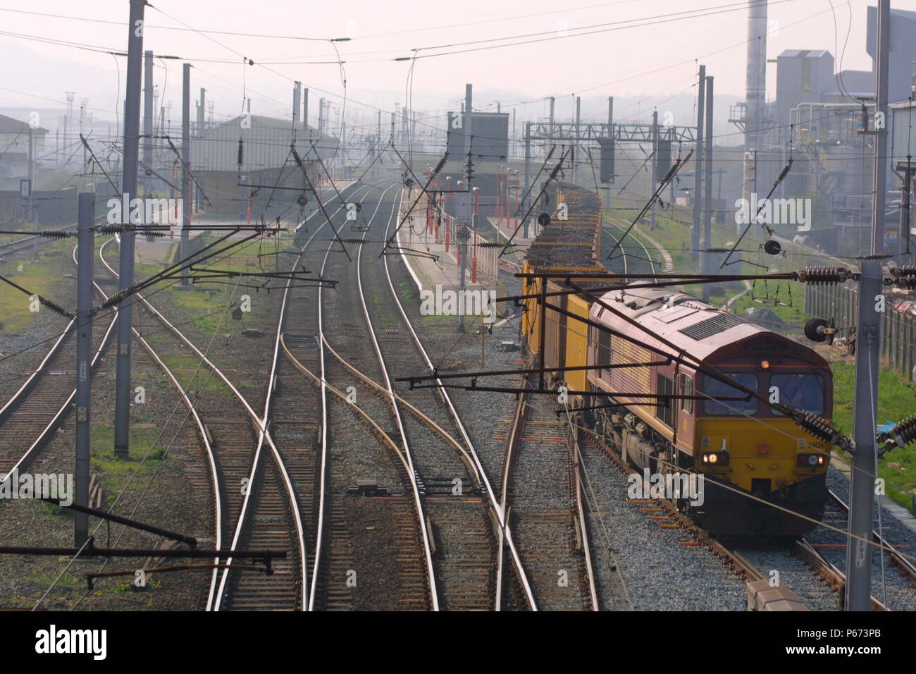 An EWS train passes through Warrington Bank Quay Station under wire ...