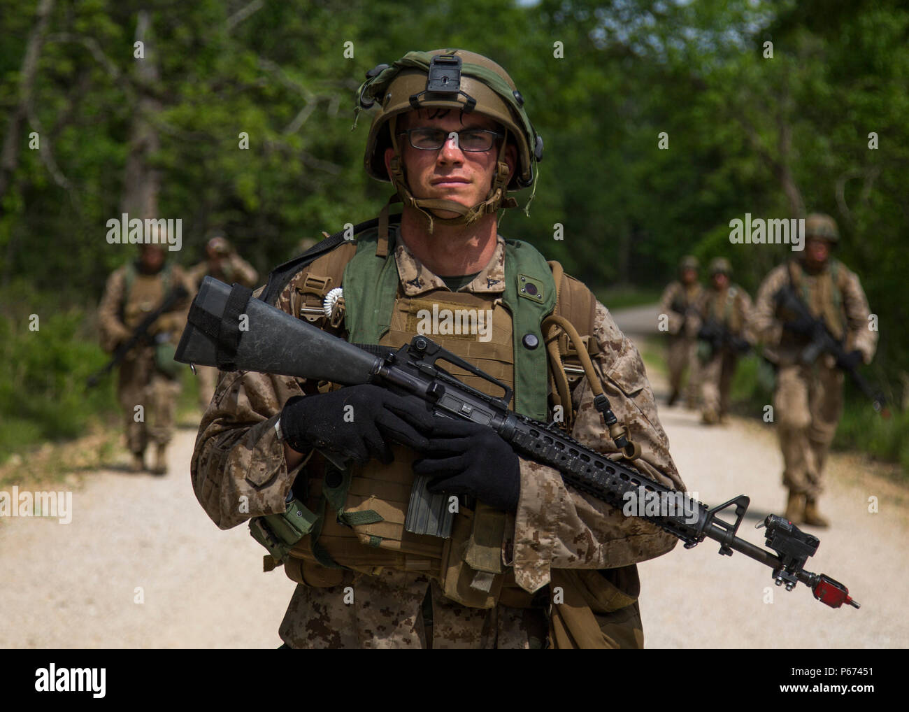 A U.S. Marine attending the Military Police Basic Course, leads a ...