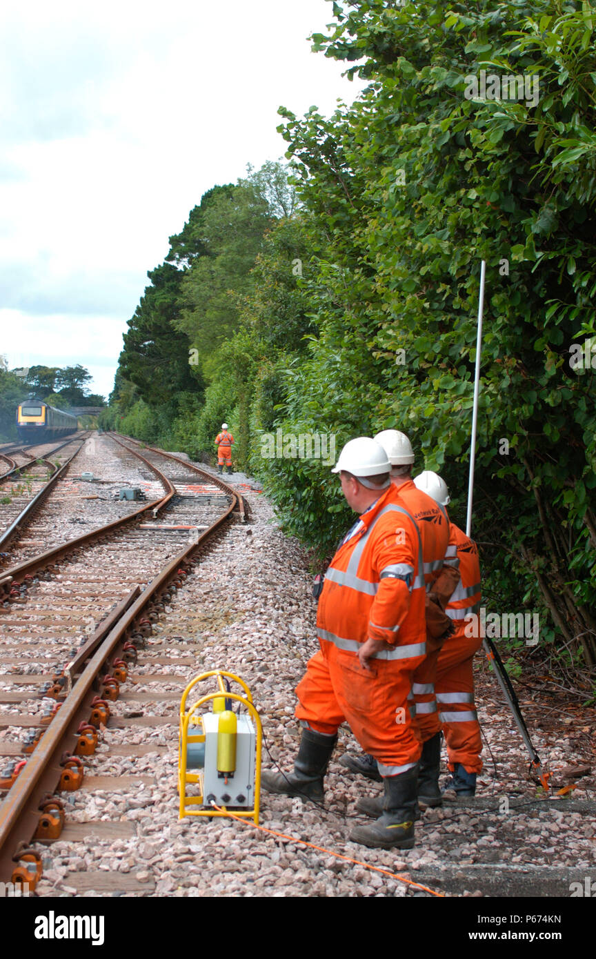 Lookout watches for oncoming train as track gang prepare worksite. July ...