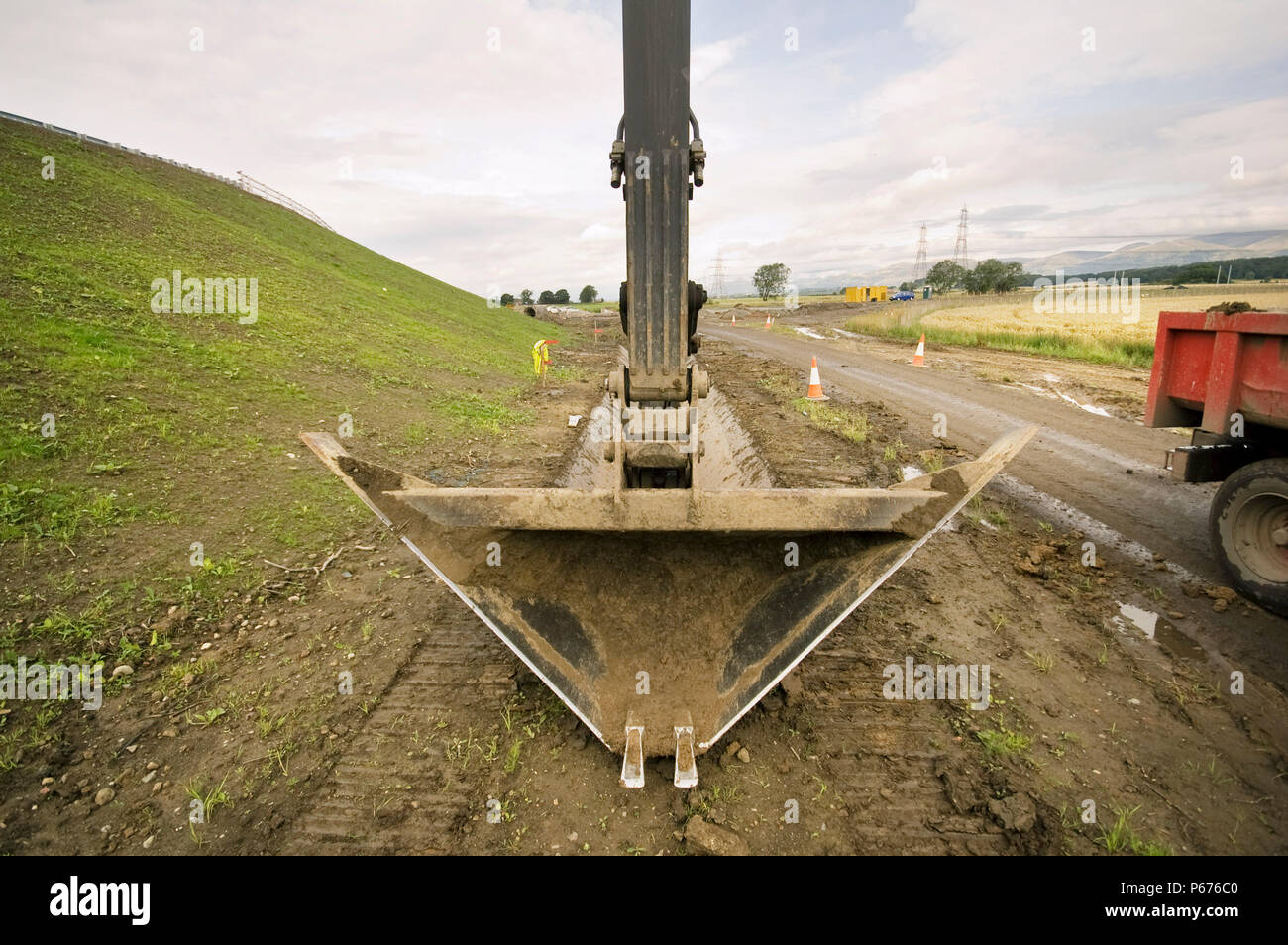 A trapezoidal excavator bucket for digging drainage ditches Stock Photo ...