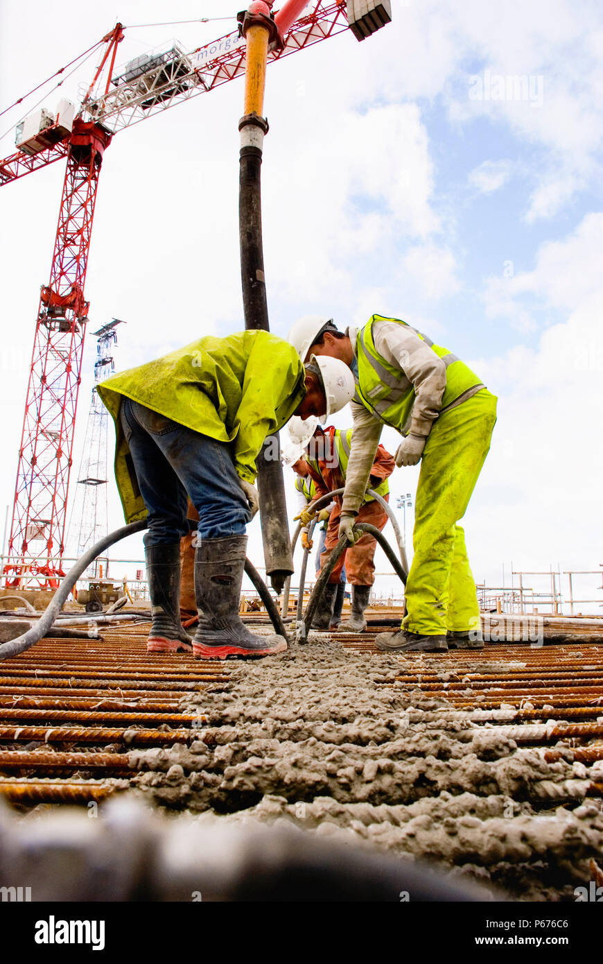 Concrete finishers at work pumping concrete into castings Stock Photo ...