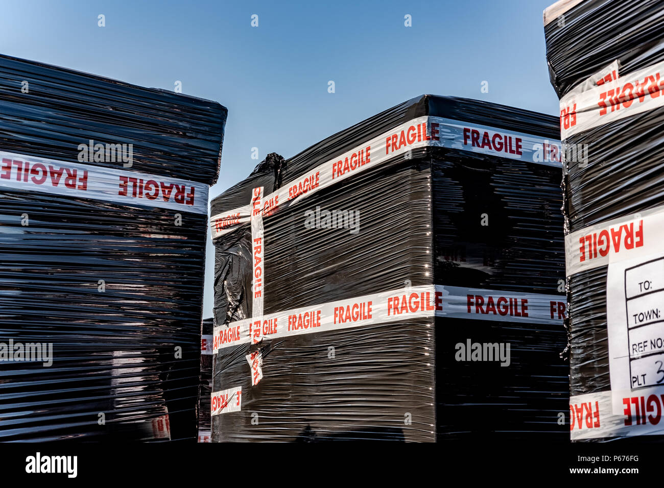 Shallow focus of tall heavy goods seen outside a dispatch warehouse ...