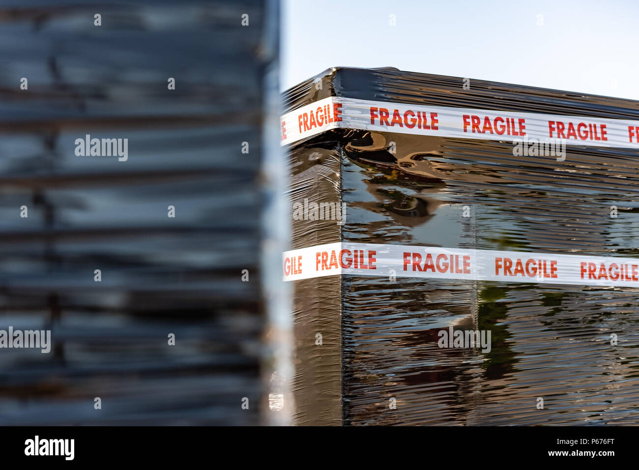 Shallow focus of tall heavy goods seen outside a dispatch warehouse ...