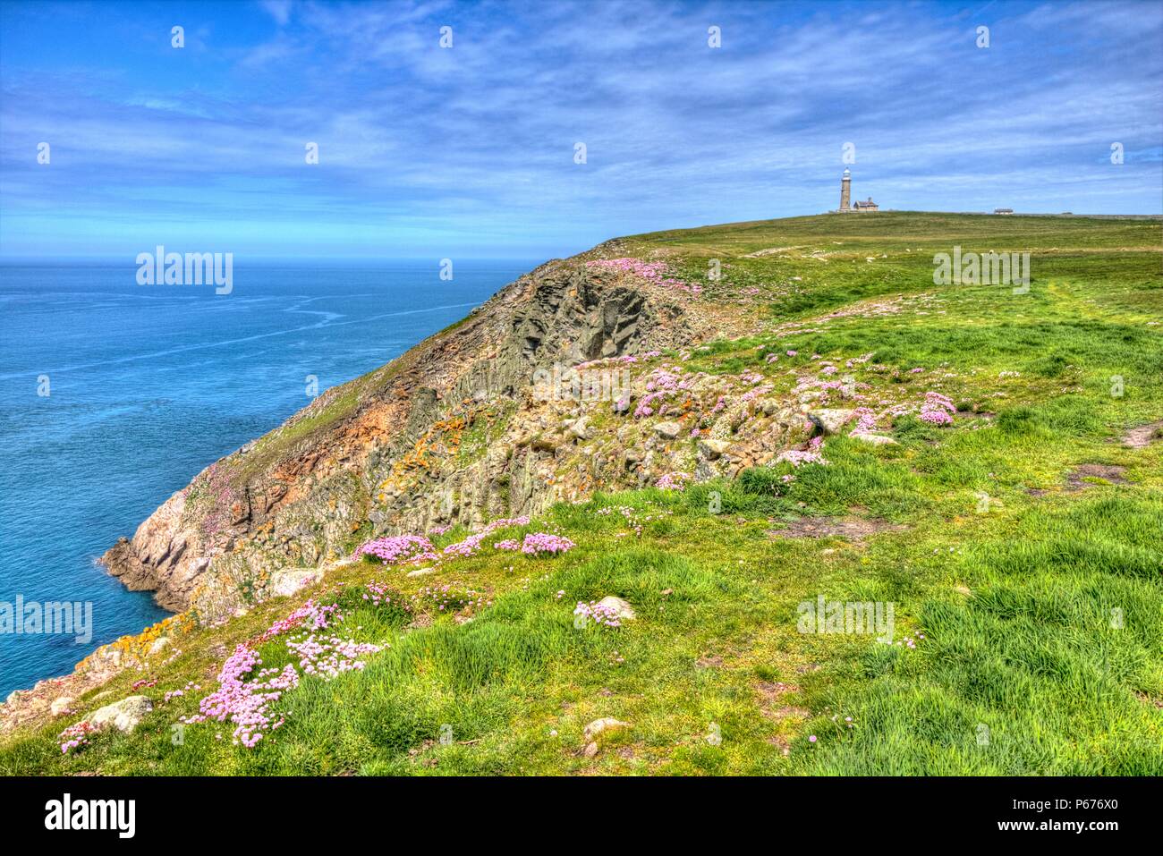 Cliffs on the west coast of Lundy Island with Old Light lighthouse in ...