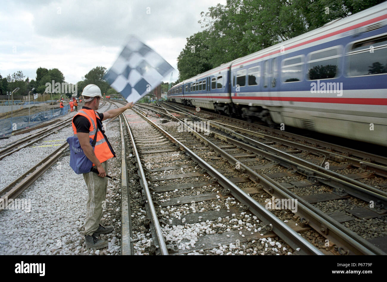Worker Signalling to Train Stock Photo - Alamy