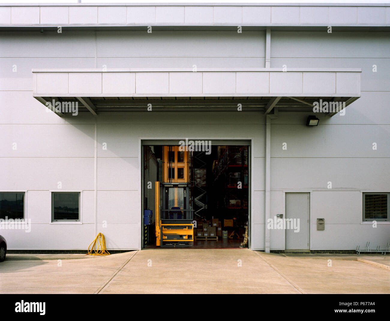 Forklift within Entrance to Warehouse Stock Photo - Alamy