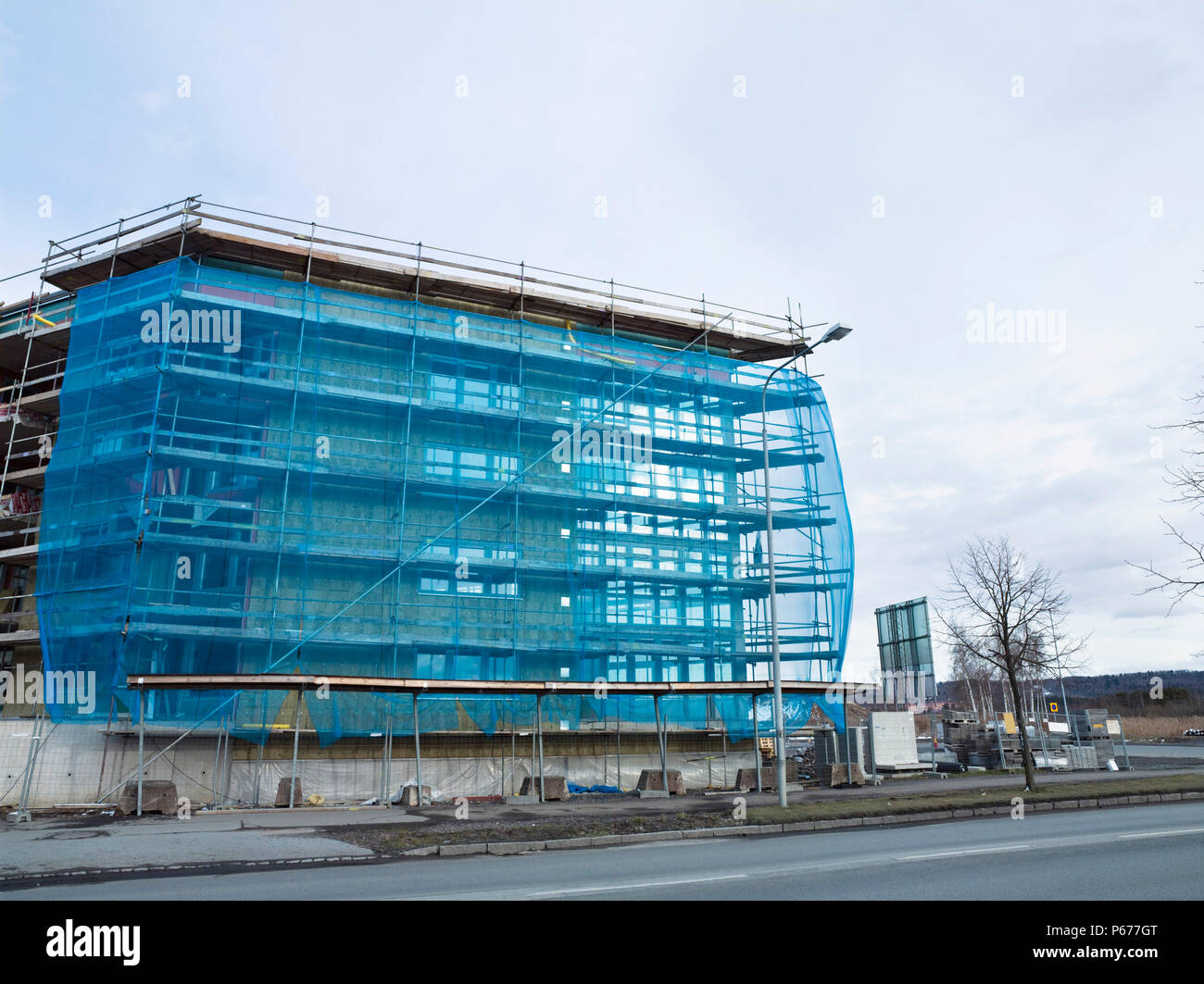 Scaffolding and sheeting surrounding building, Sweden Stock Photo - Alamy