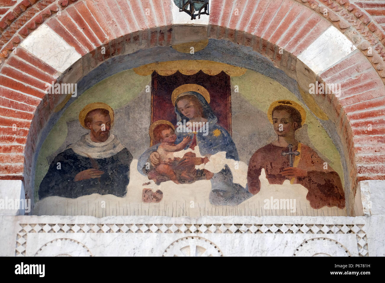 Virgin Mary with baby Jesus and Saints, lunette over the entrance door ...
