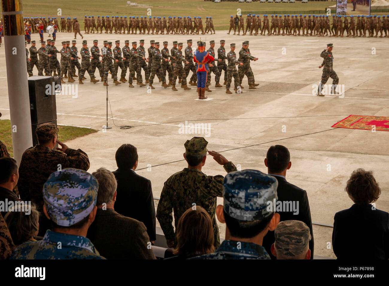 A multinational formation of troops conduct a pass in review during the ...