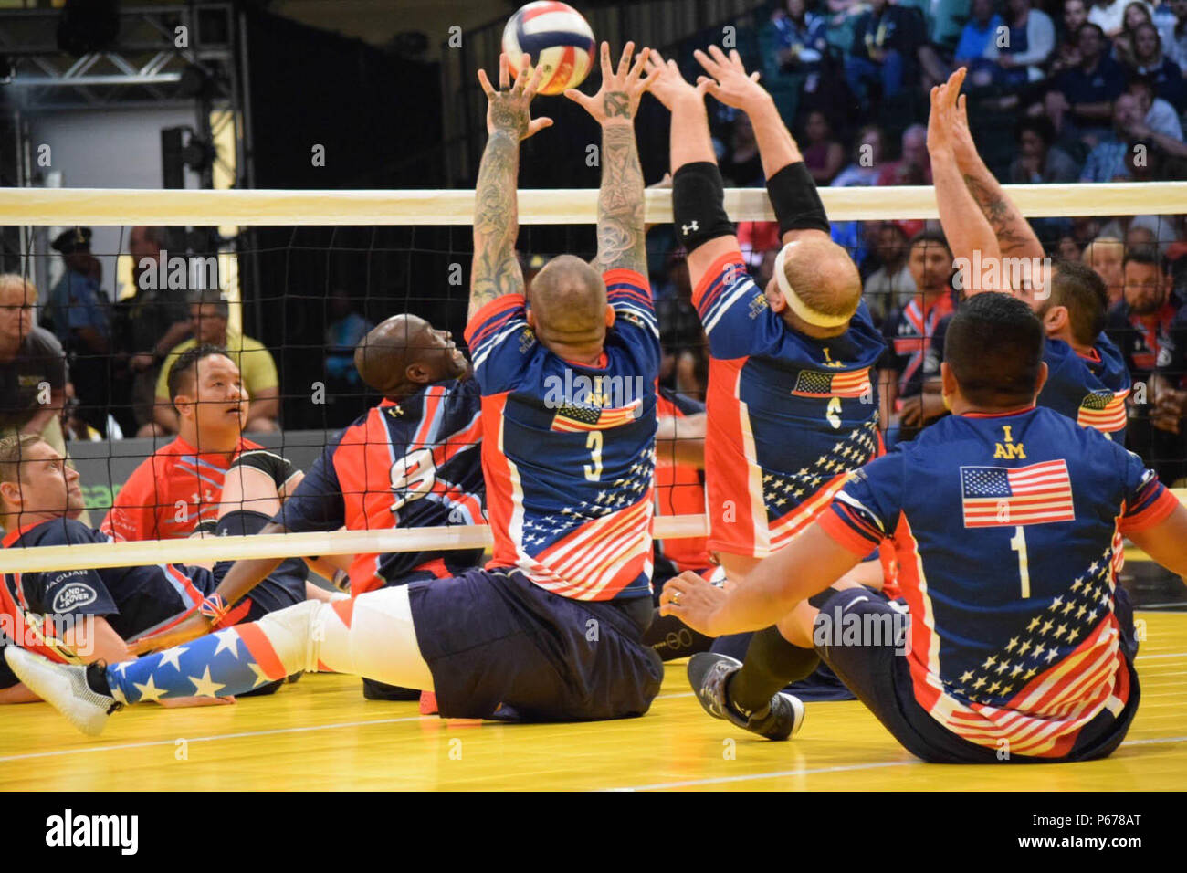 U.S. teammates black a serve in the gold medal match in sitting ...