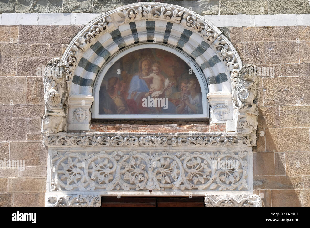 Virgin Mary with baby Jesus, lunette on the portal of San Giusto church ...