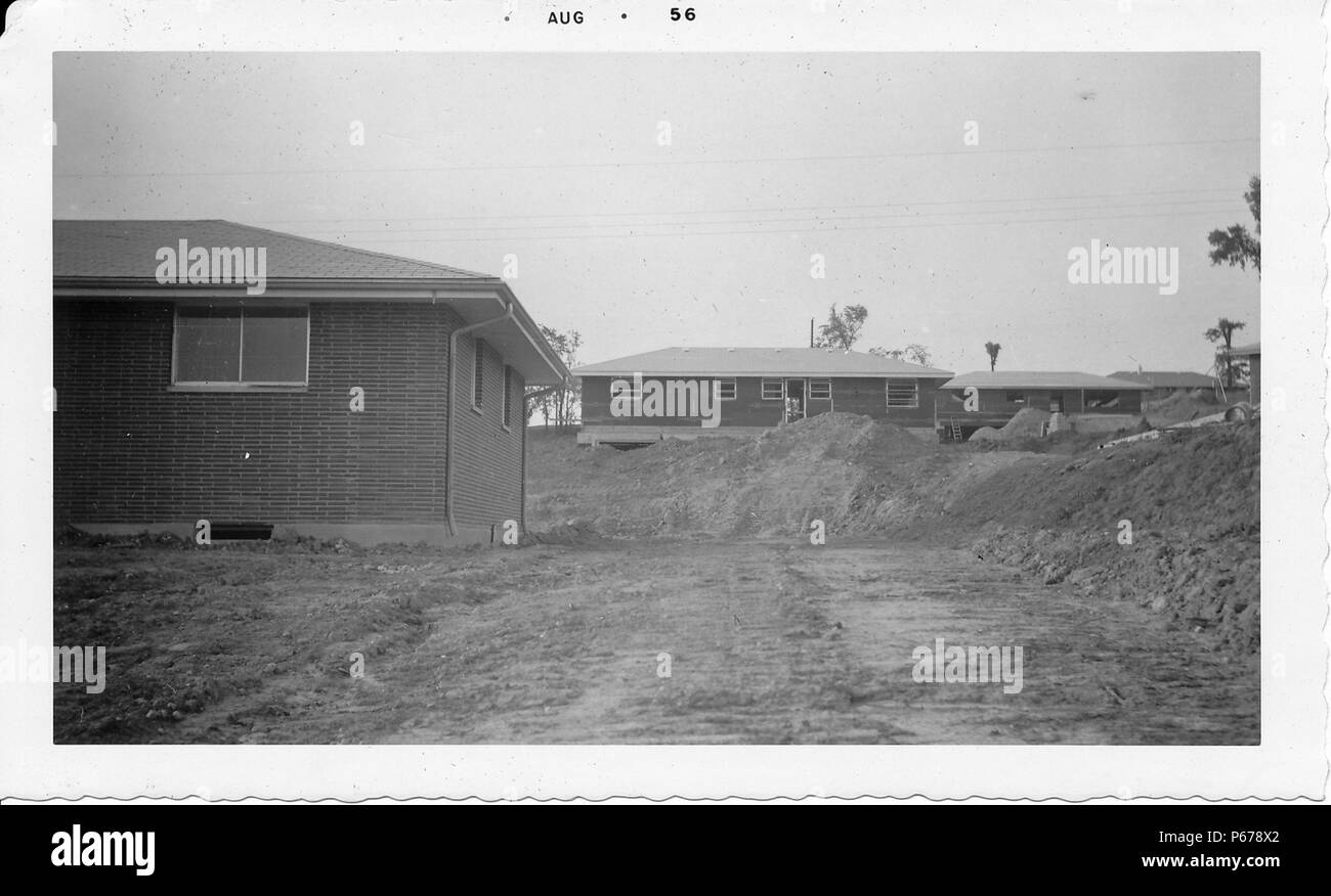Black and white photograph, showing several single-story, tract houses ...