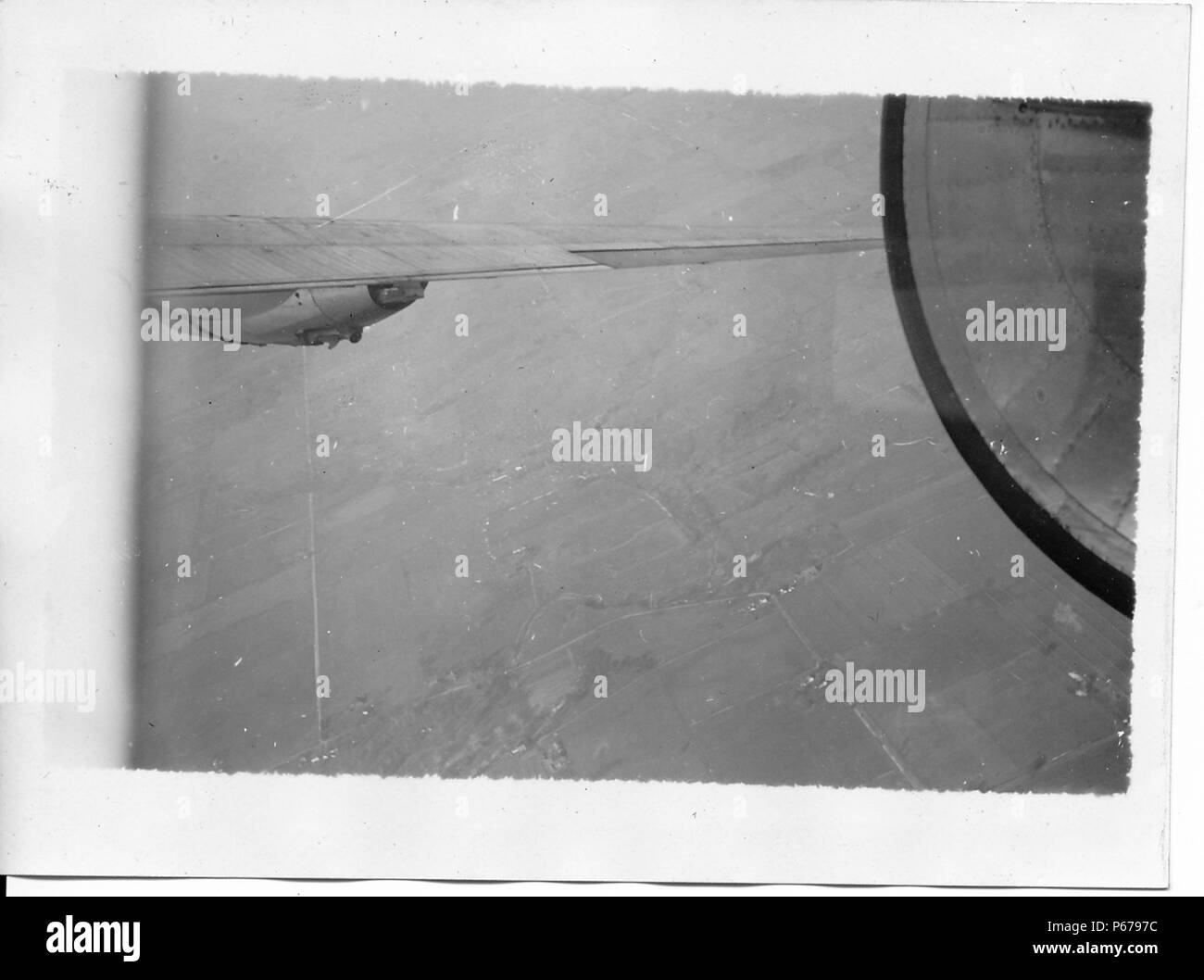 Black and white photograph, shot from the interior of an airplane in ...