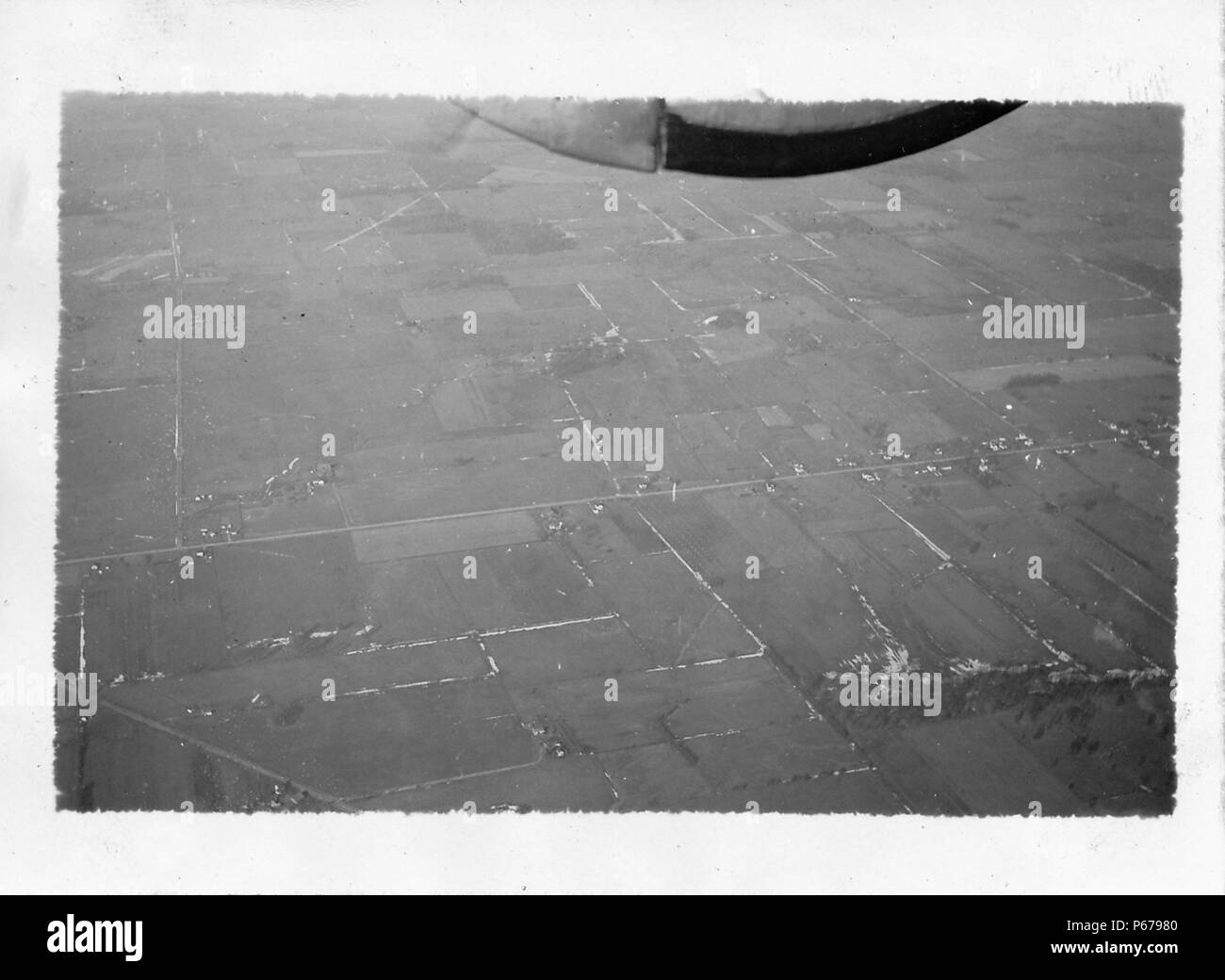 Black and white photograph, shot from the interior of an airplane in ...