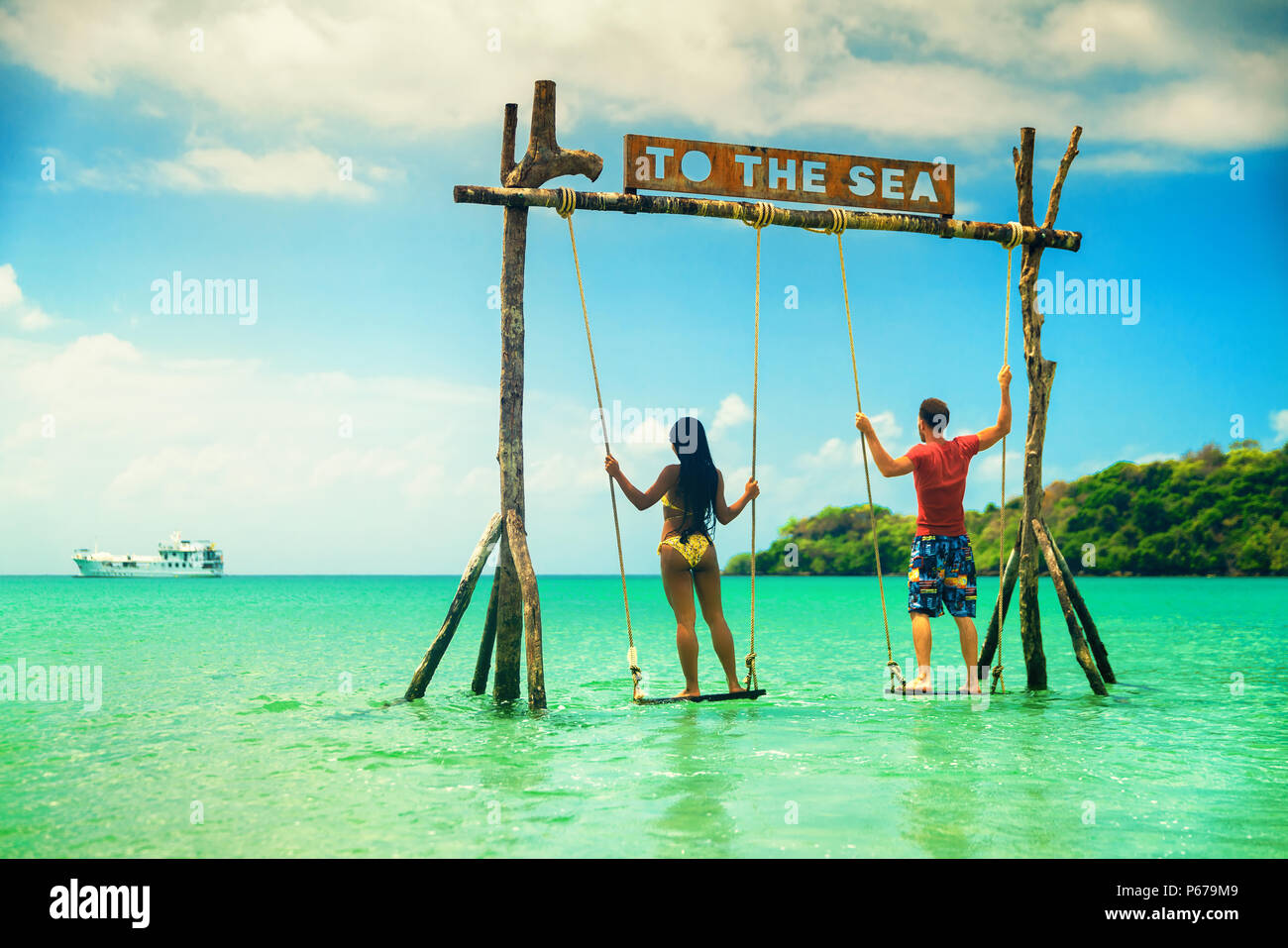 Romantic couple on sea beach on rope swing . Family vacation on ...
