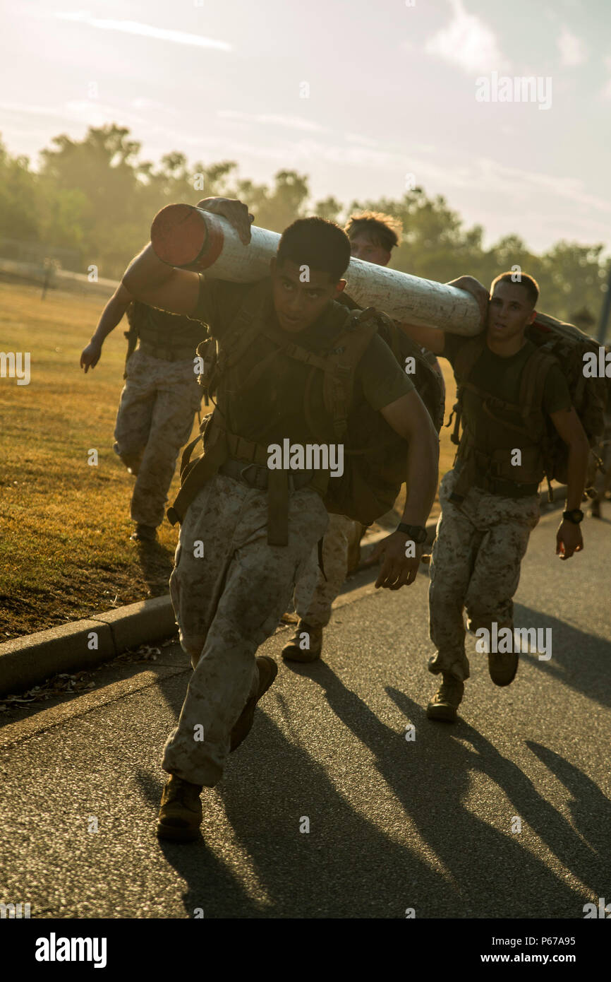 Marines and sailors start a squad competition carrying main packs and ...