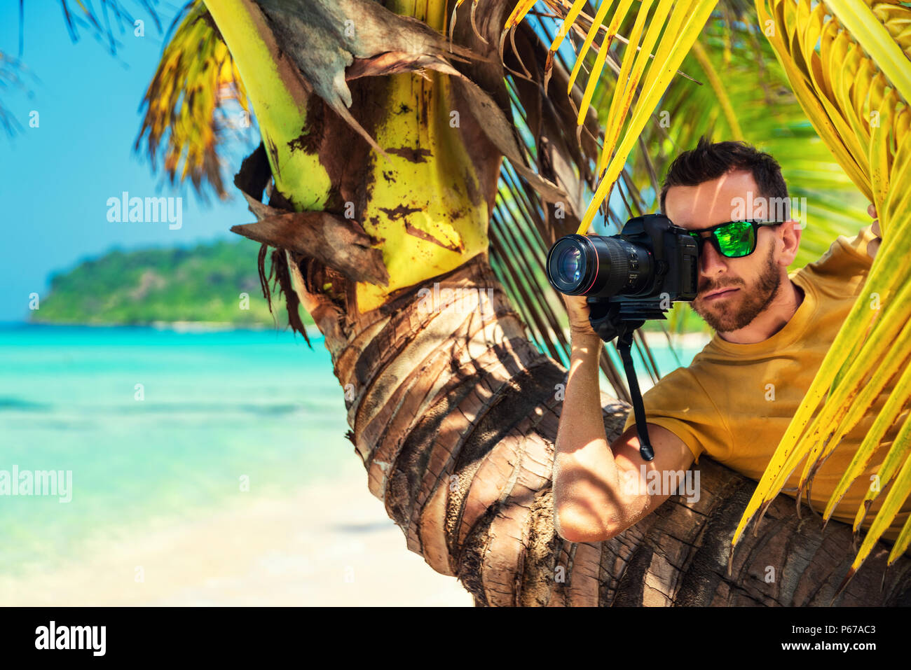 Man in sunglasses holding camera and snapping photos hidden in the ...