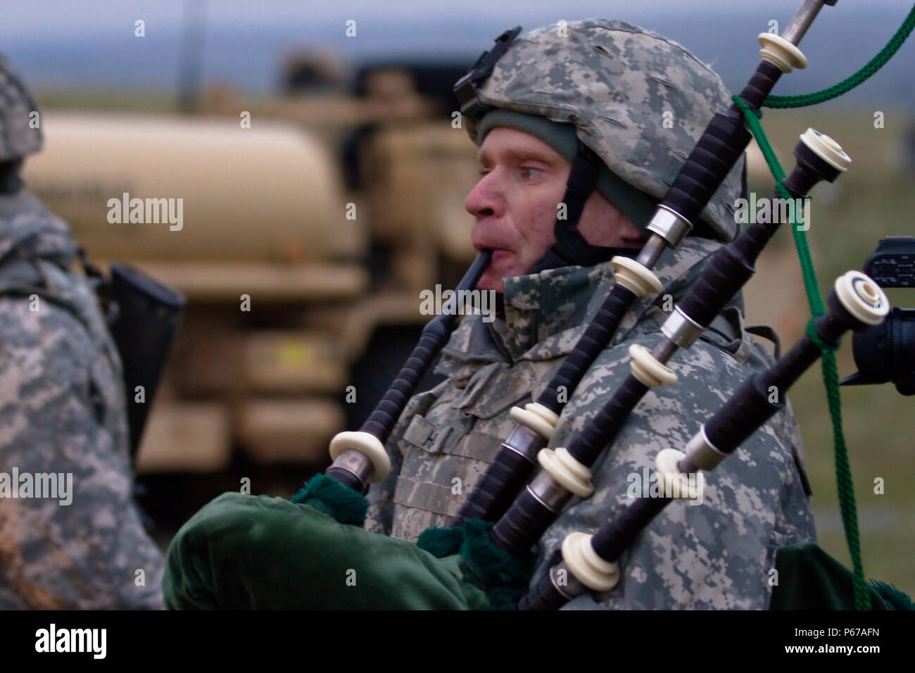 An NCO from 213th Forward Support Company plays the bagpipes in the ...
