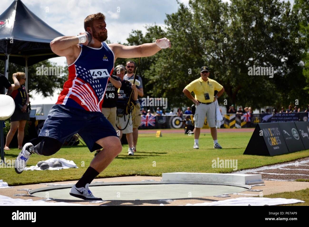 Navy Hospital Corpsman 2nd Class (Ret.) Max Rohn launches the shot put ...