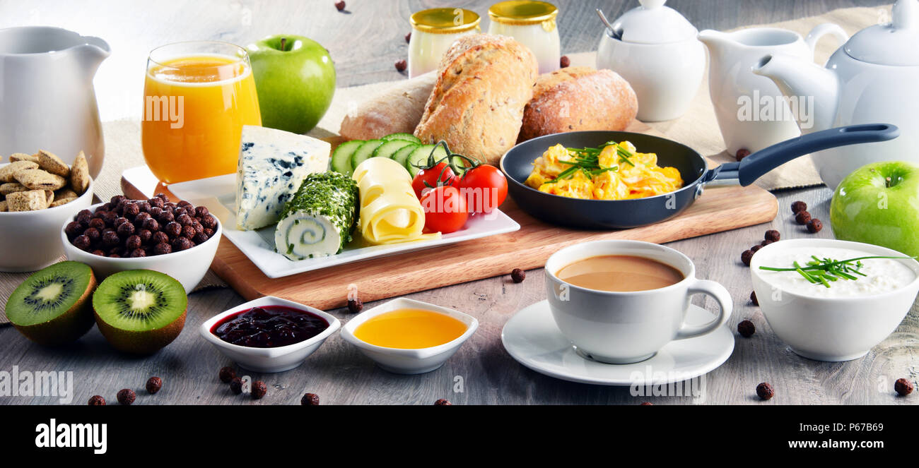 Breakfast served with coffee, orange juice, cheese, cereals and ...