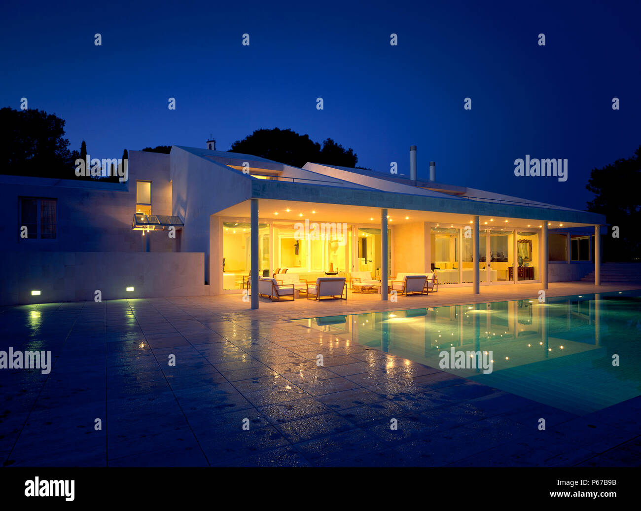 View of a lit house with a swimming pool Stock Photo - Alamy