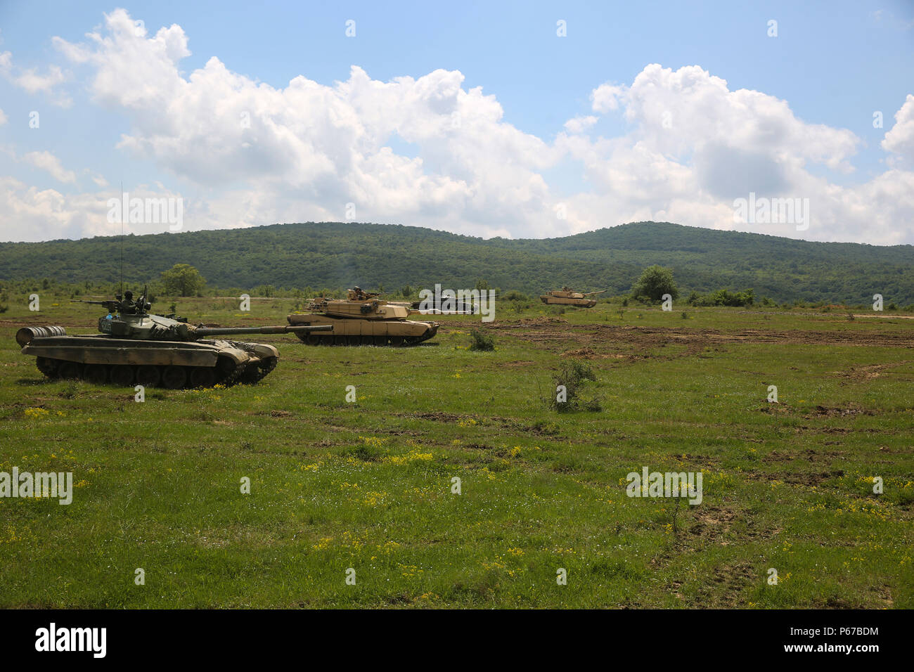 U.S. Marine Corps M1A1 Abrams tanks search and assess the area with ...