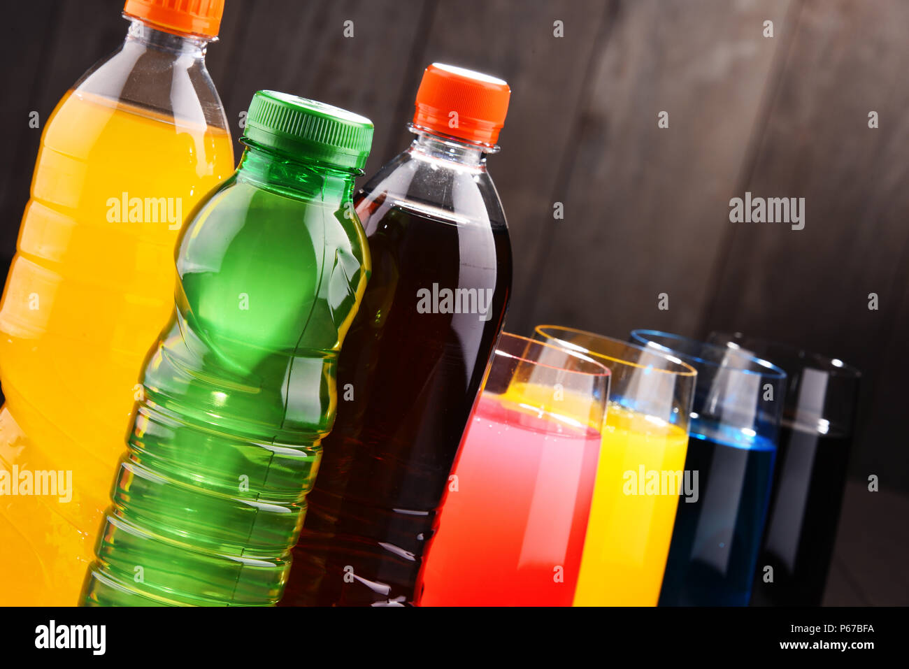 Glasses and bottles of assorted carbonated soft drinks in variety of ...