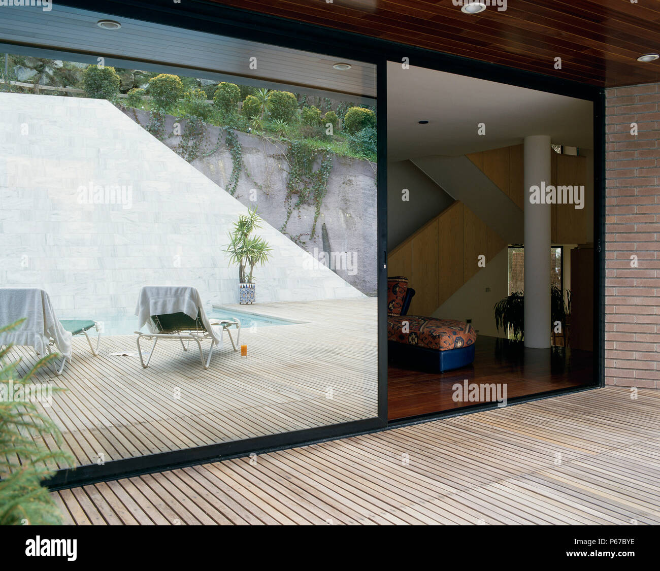 View of a swimming pool and deck chairs reflected in a mirror Stock ...