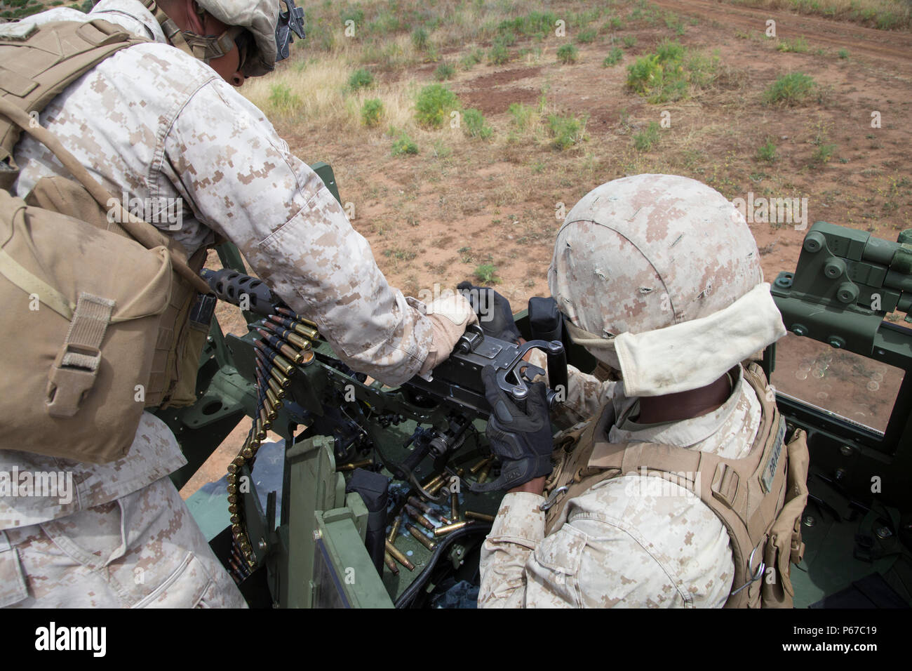 Marines load rounds into an M2 .50-caliber machine gun during a live ...