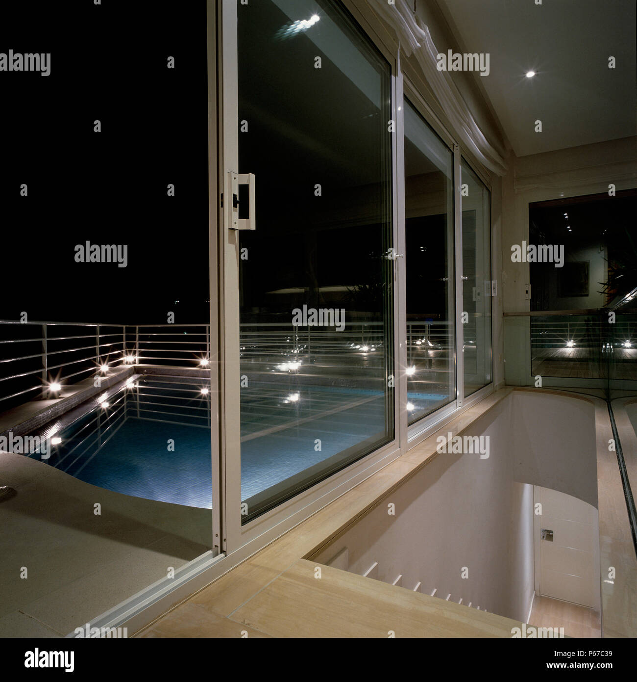 View of a swimming pool through sliding doors Stock Photo - Alamy