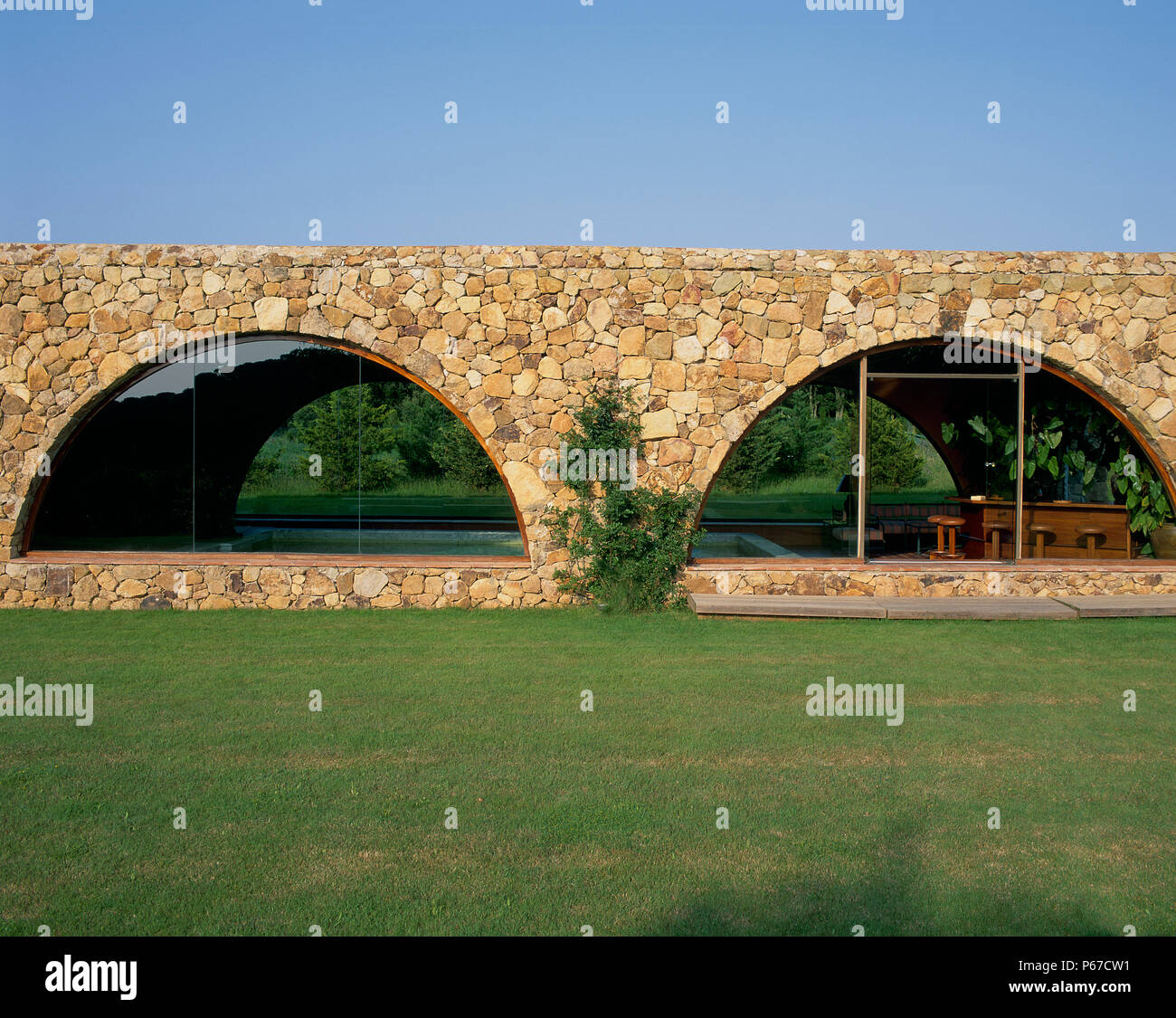 View of an indoor swimming pool seen through arches Stock Photo - Alamy