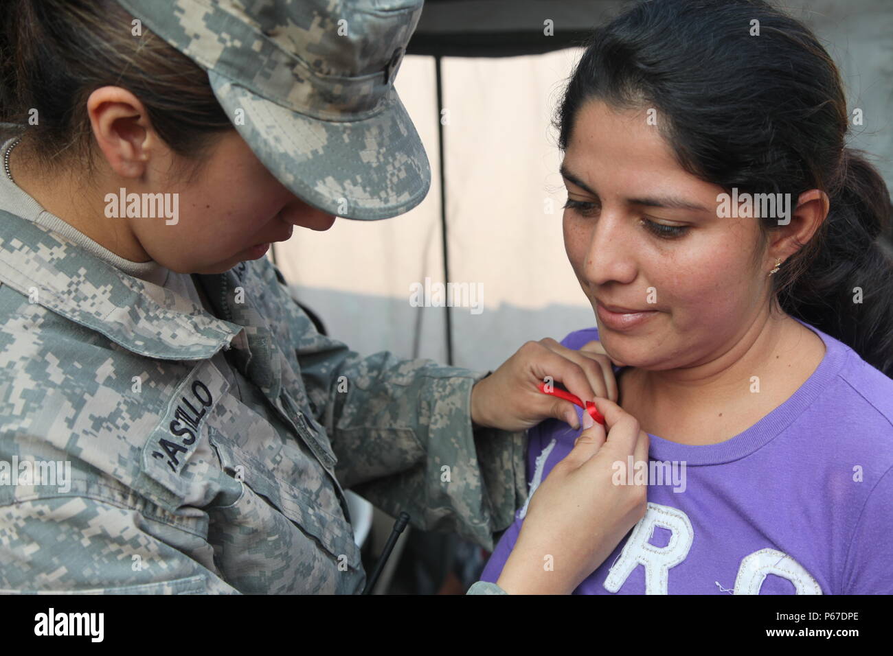 U.S. Army Spc. Jessie Castillo, with the 413th Civil Affairs, pin ...