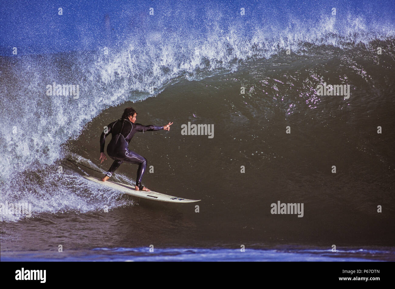 Surfer riding in the tube on a big wave at Cabo Blanco, Peru Stock ...