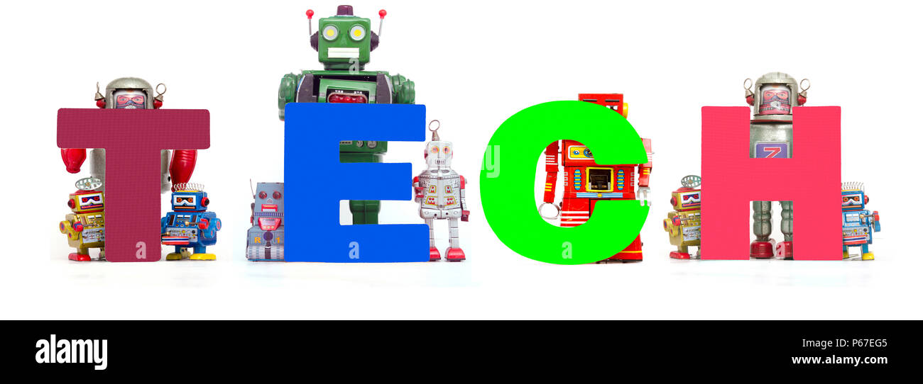 retro tin robot toys hold up the word TECH isolated on white Stock ...