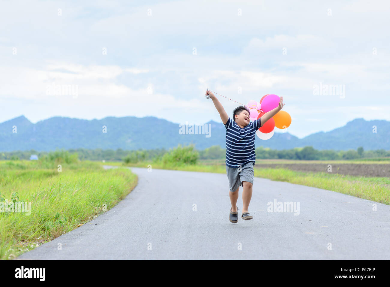 Happy fat boy running with balloon on the road, Lifestyle and leisure ...