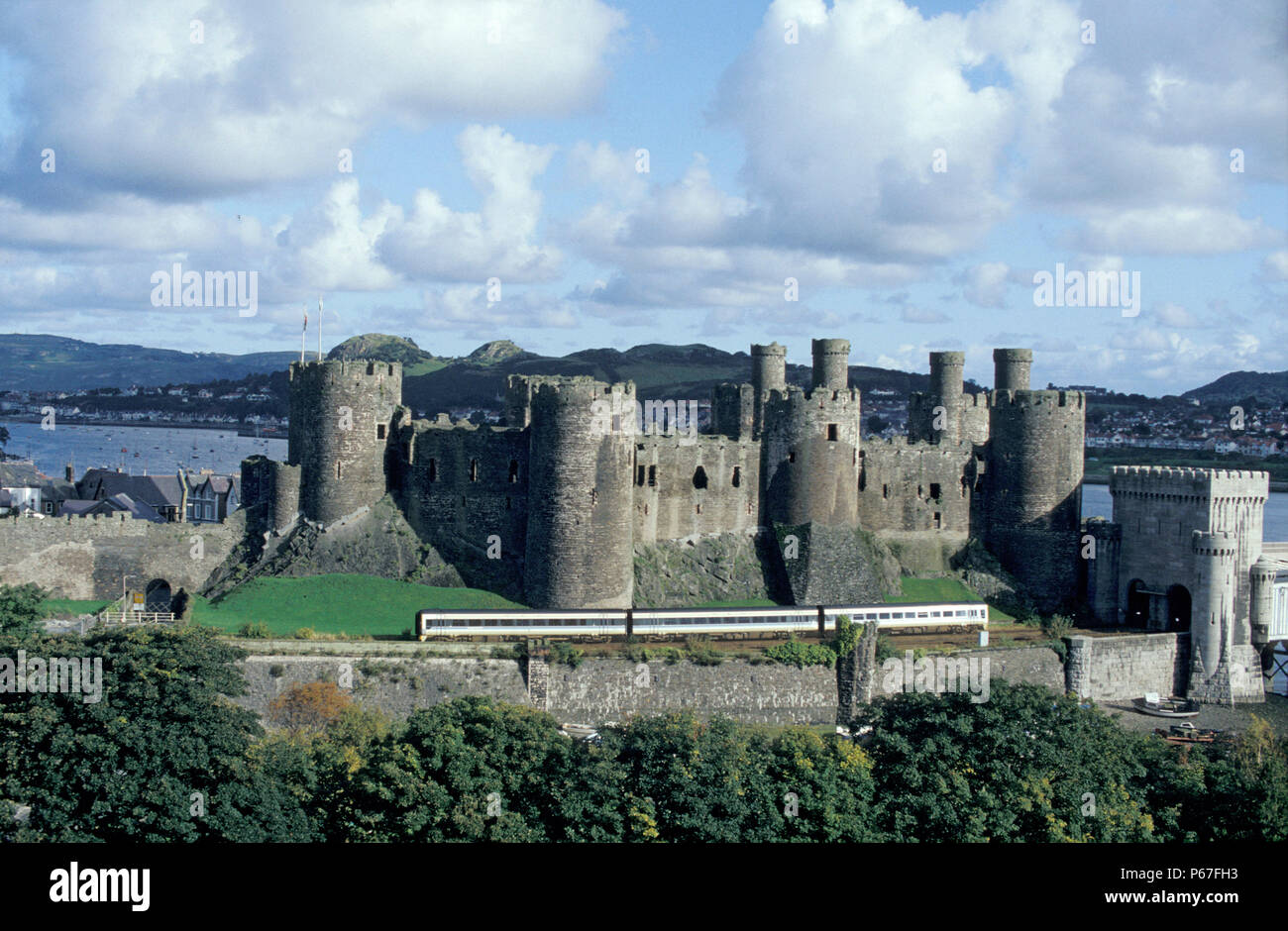 DMU passing the historic castle at Conway on the north Wales coast with ...