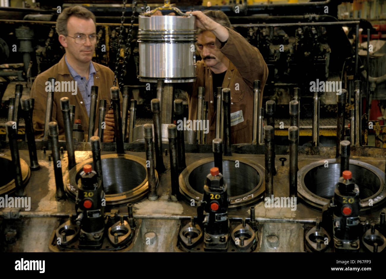 Engineers fit a new piston during engine refurbishment at Doncaster ...
