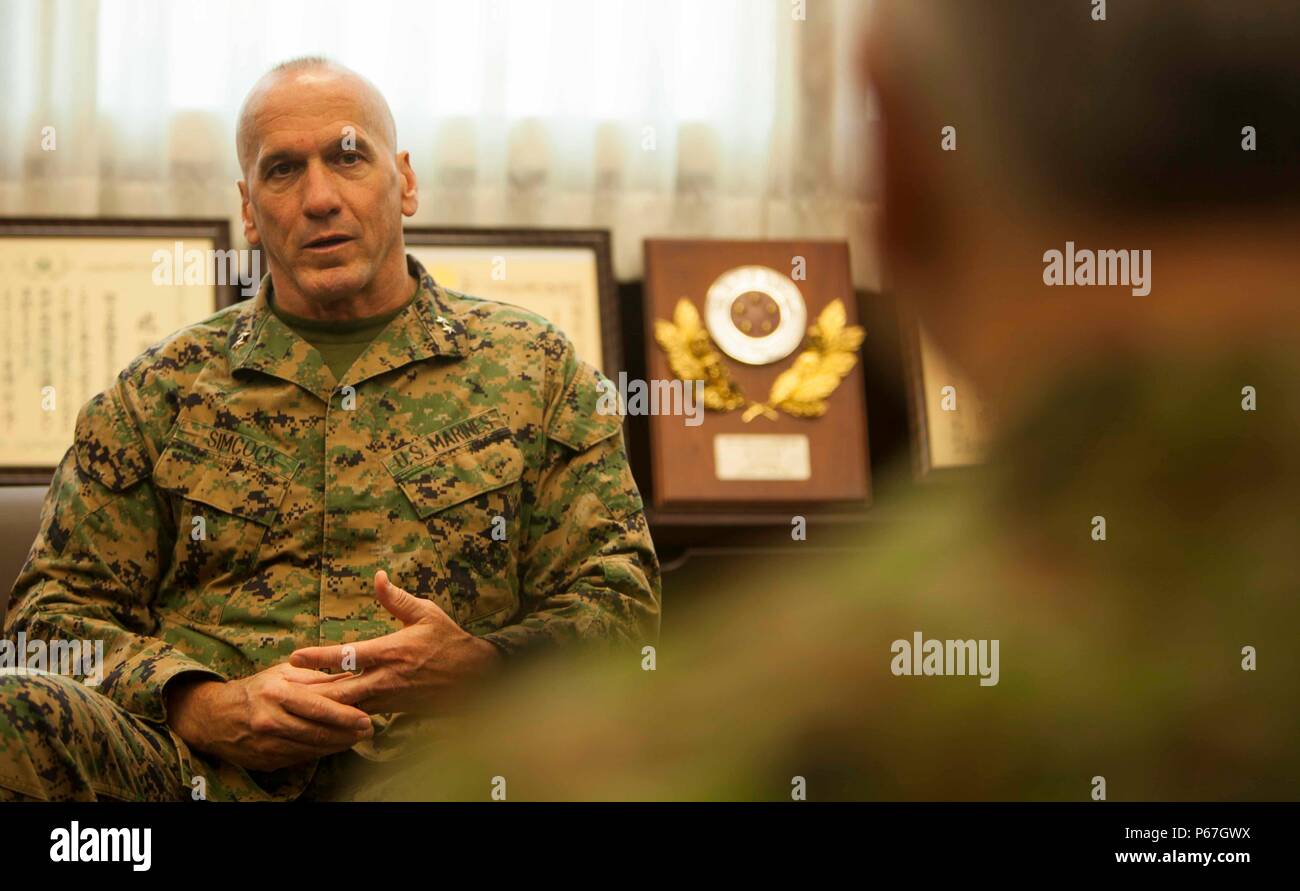 Maj. Gen. Richard Simcock converses with Japanese officials during a ...