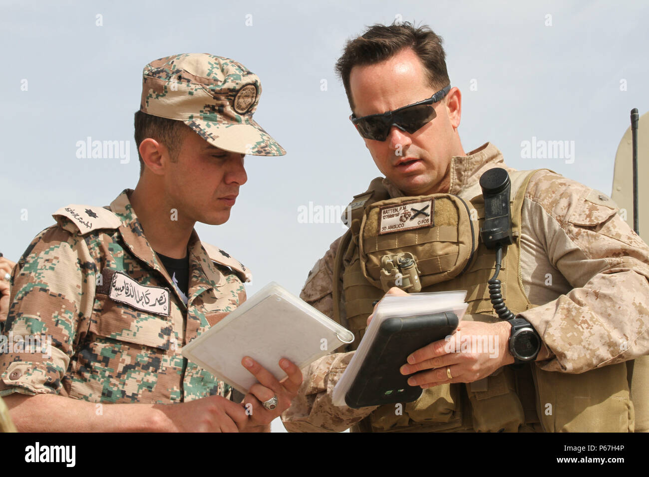 A U.S. Marine and a Jordanian Armed Forces servicemember prepare to ...