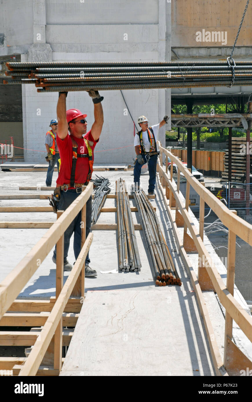 steel worker, with load of rebar, PCL Contractors; Conference Centre ...