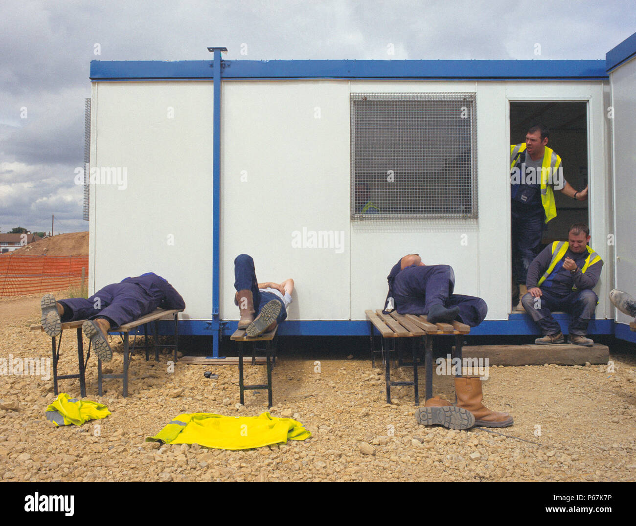 Construction workers relaxing during a break Stock Photo - Alamy