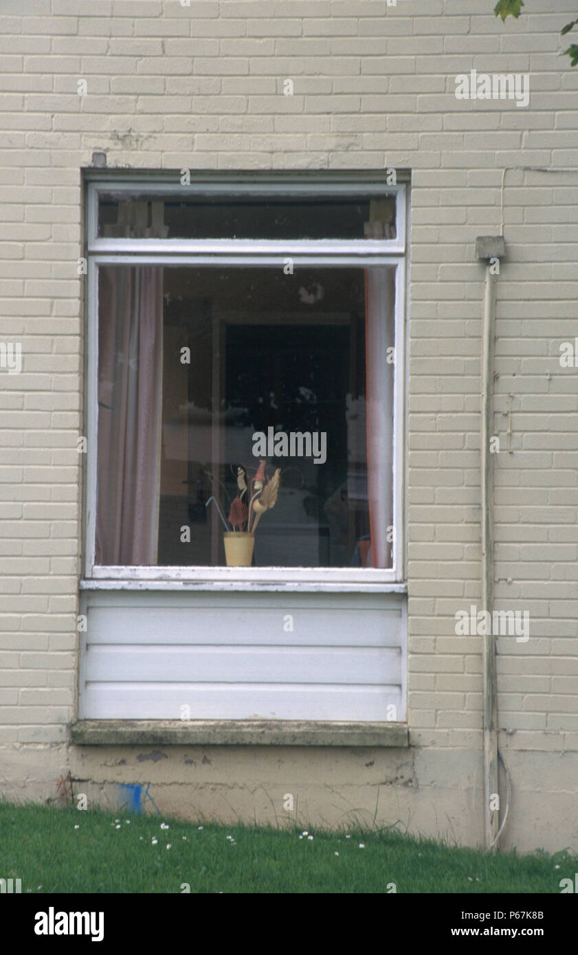 Council house presenting a window in need of repair Stock Photo - Alamy