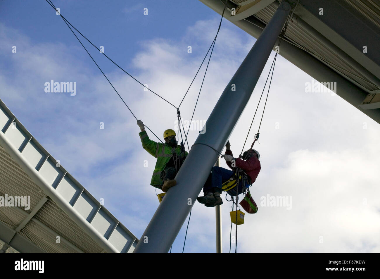 Construction workers abseiling during maintenance work Stock Photo - Alamy