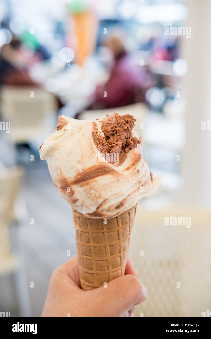 Hand holding Chocolate Gelato, Ice-cream with blur background Stock ...