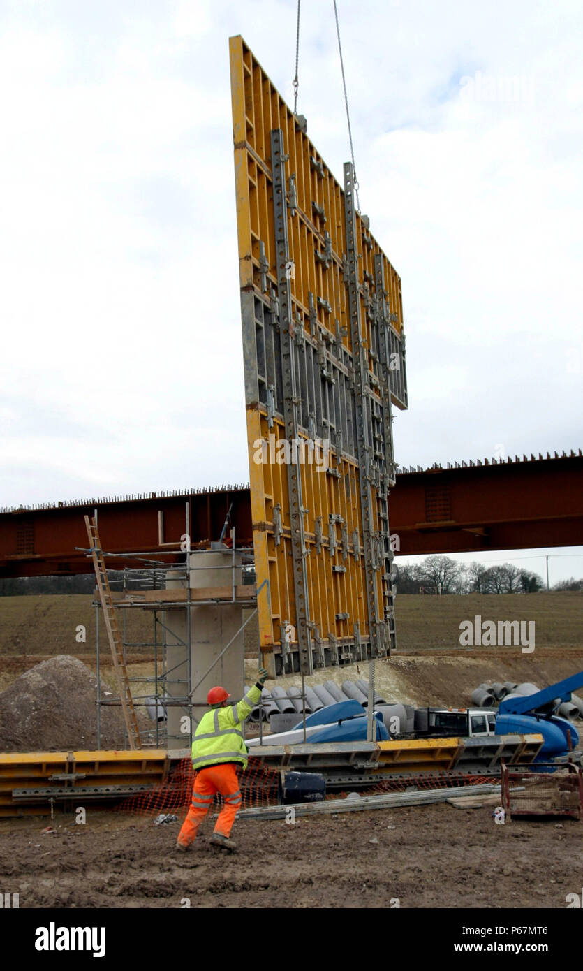 Crane lifting building material on site, with help of a construction ...