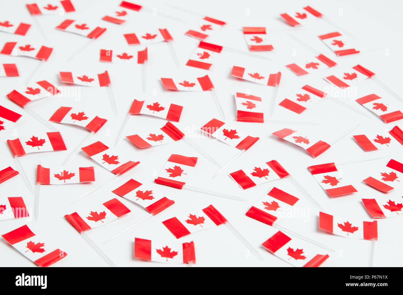 lots of small canadian flags on a white background Stock Photo - Alamy
