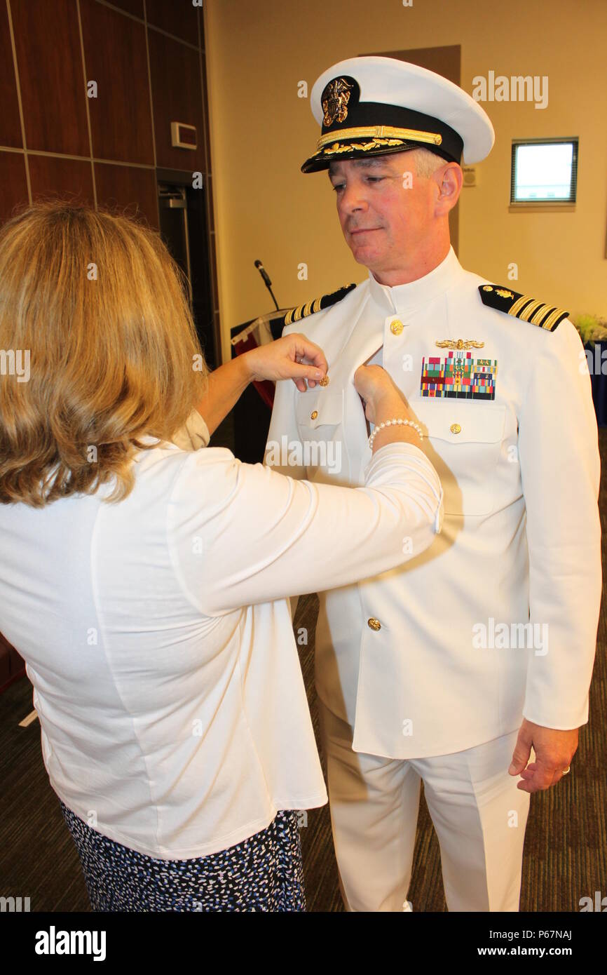 Wife Renee Kemper affixes the Command Ashore insignia to her husband’s ...